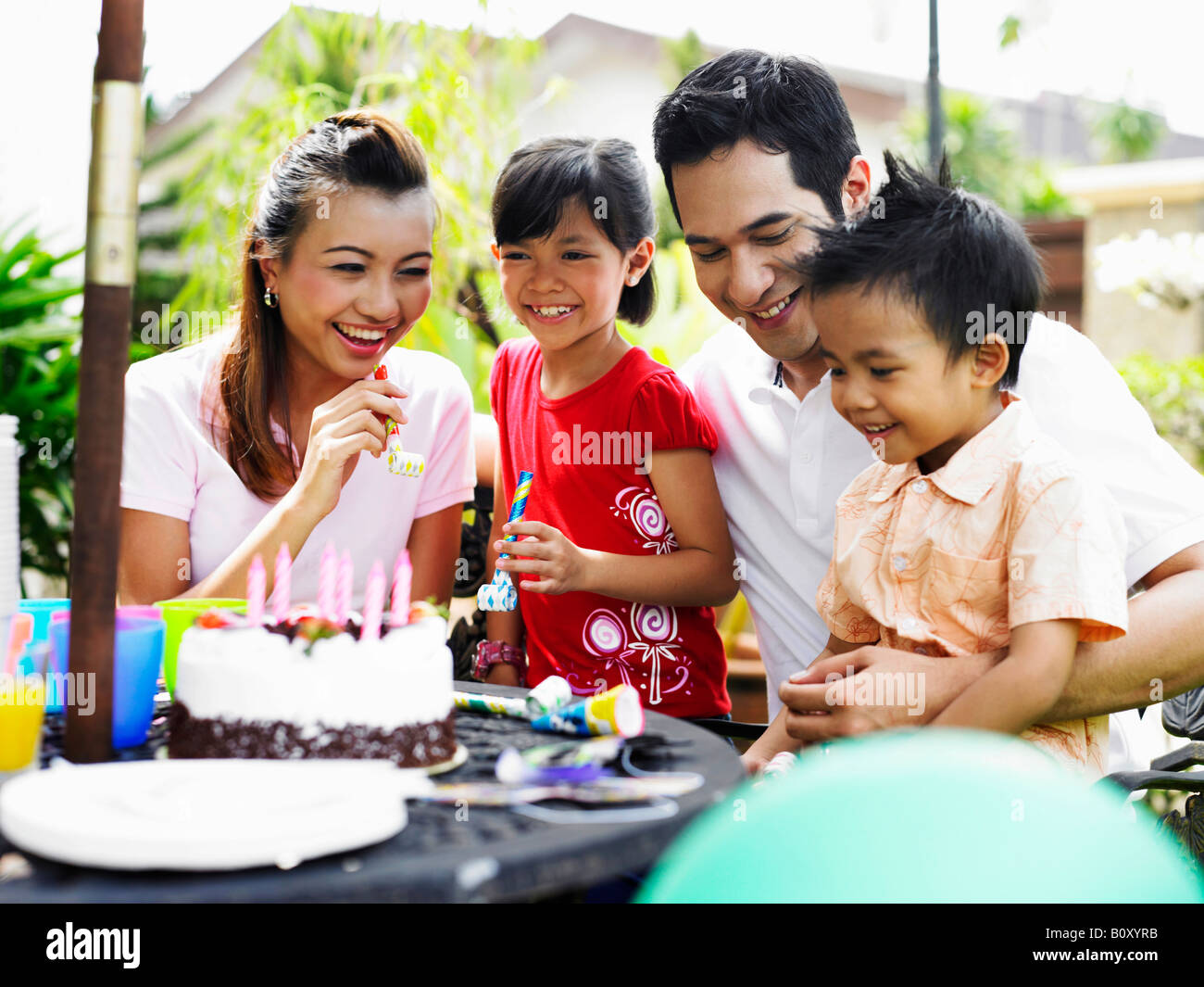 Family of four laughing out loud, at a party Stock Photo - Alamy