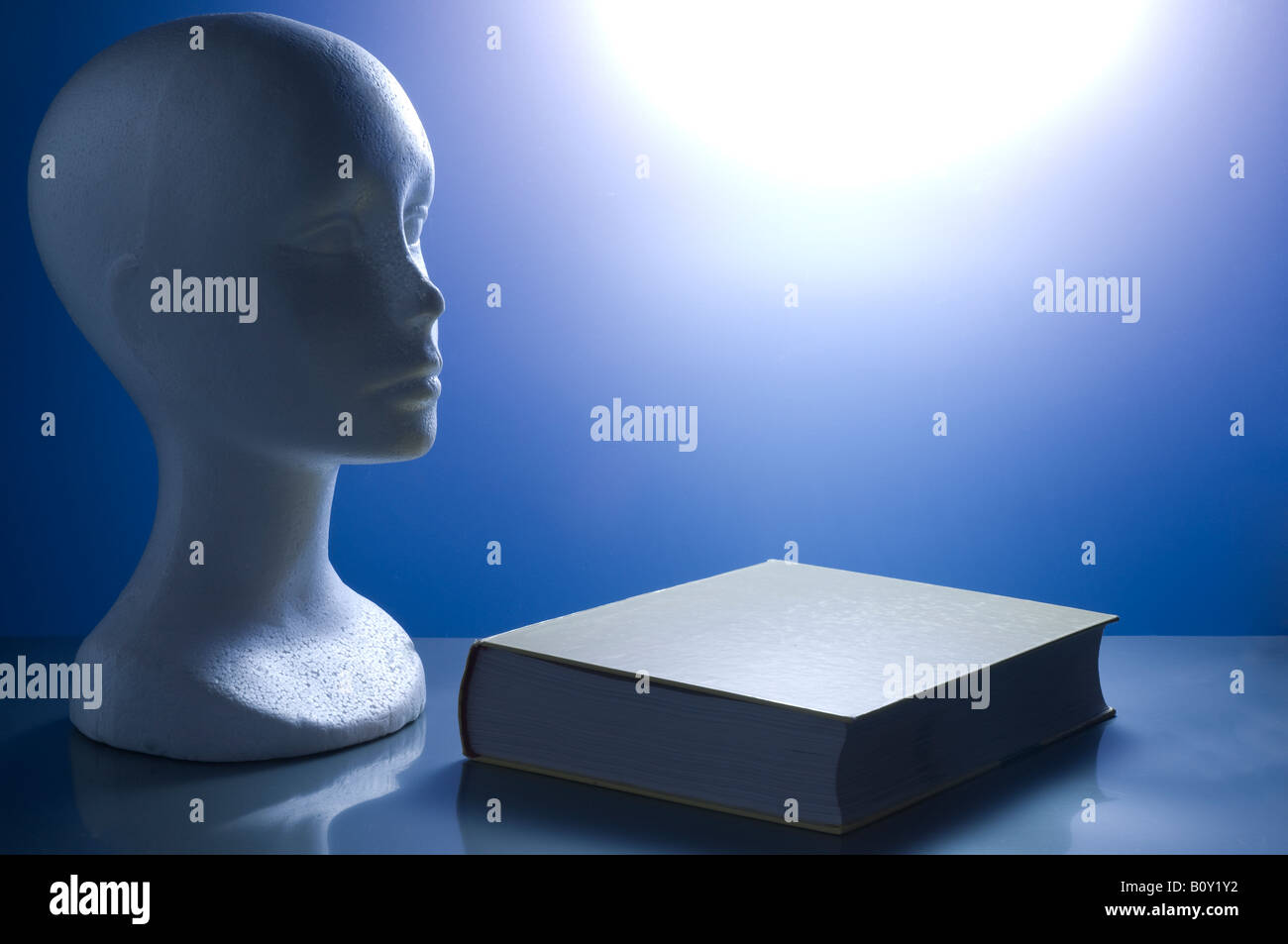 a polystyrene head with a book on the table Stock Photo - Alamy