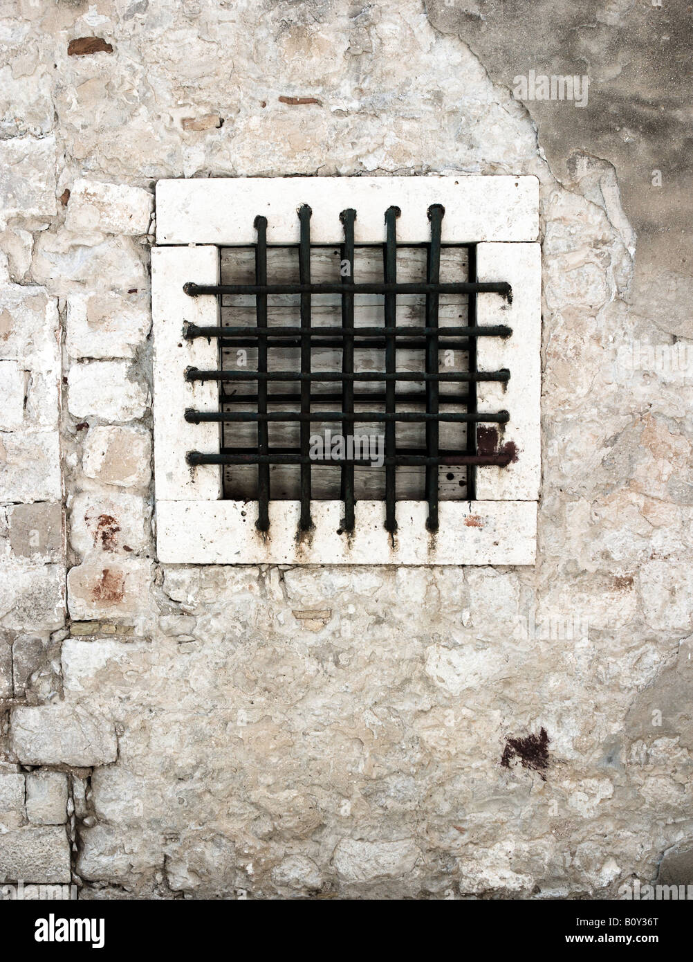 Bared or grilled window in an old wall Stock Photo - Alamy