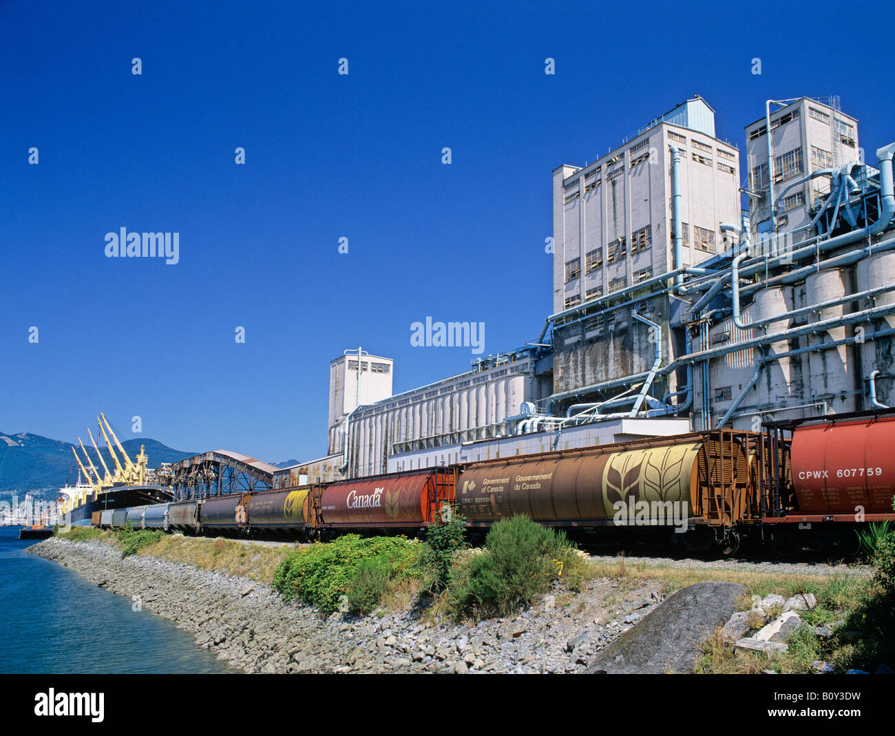 ship and train with grain cars at "grain elevator Stock Photo - Alamy