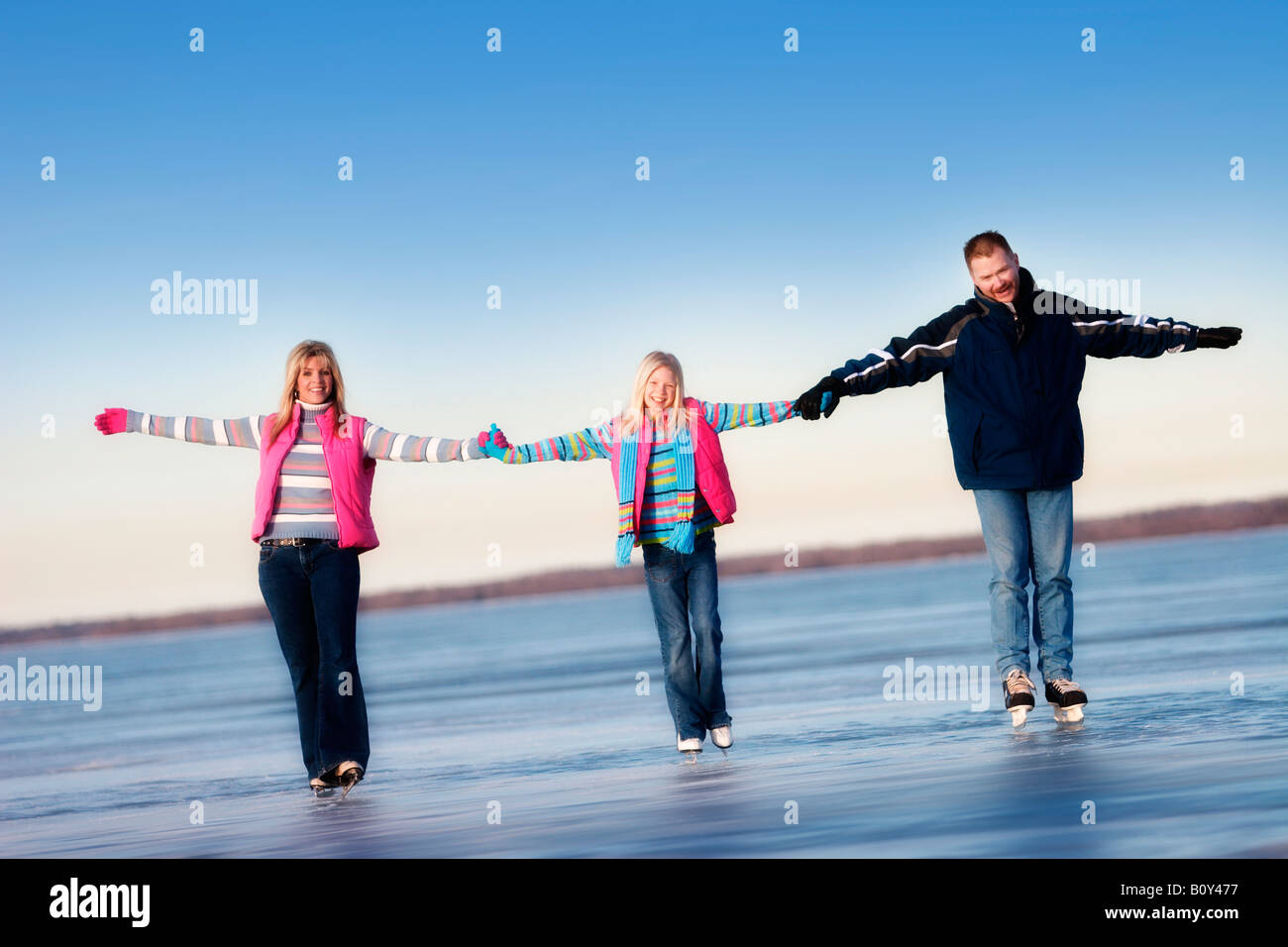 Family skating together Stock Photo - Alamy
