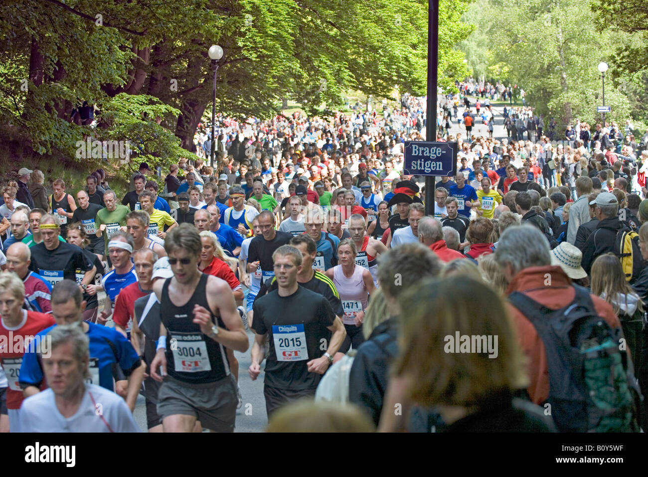 Crowds of people running in an athletic competition and audience lining ...