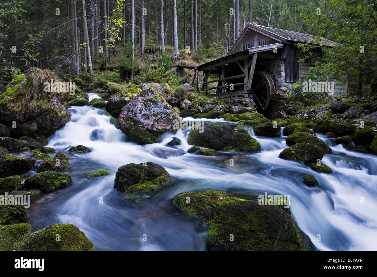 Austria, Golling, Waterfall overlooked by small wooden watermill Stock ...