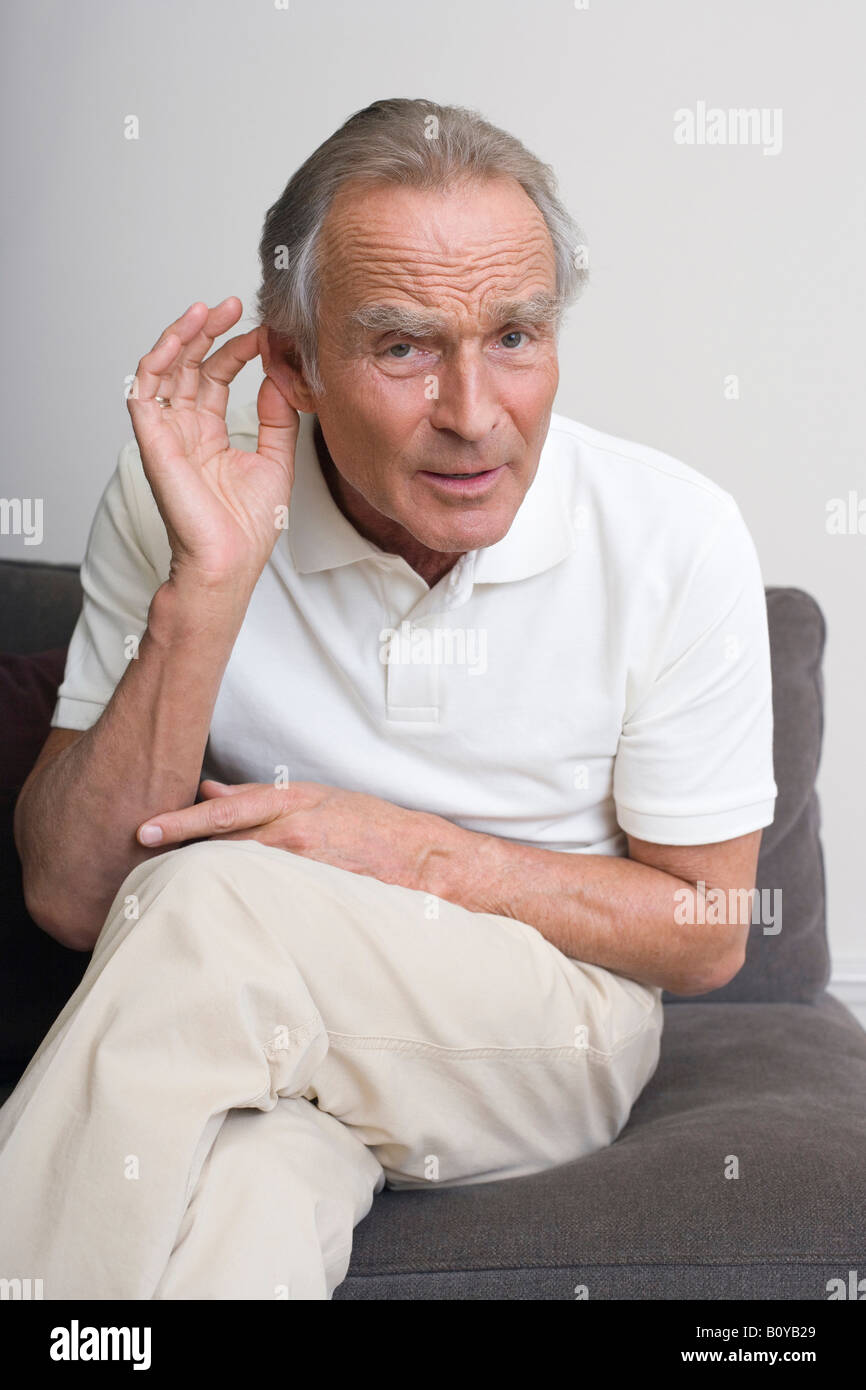 Senior man hand to ear, portrait Stock Photo - Alamy