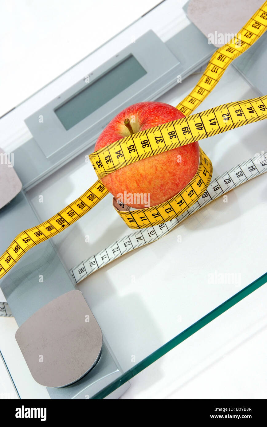 apple with tape measure on a scale Stock Photo - Alamy