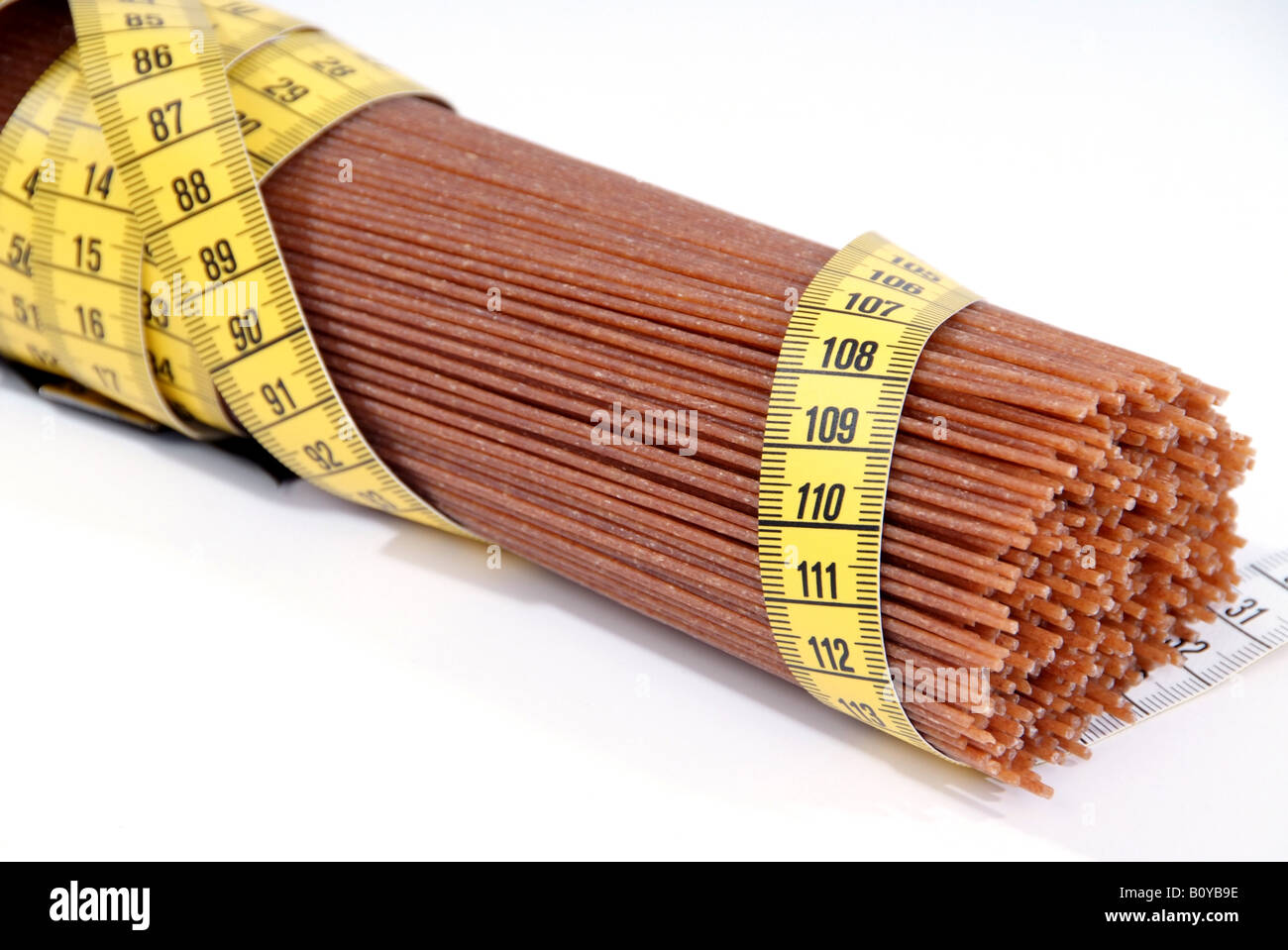 wholemeal spaghetti with tape measure Stock Photo - Alamy