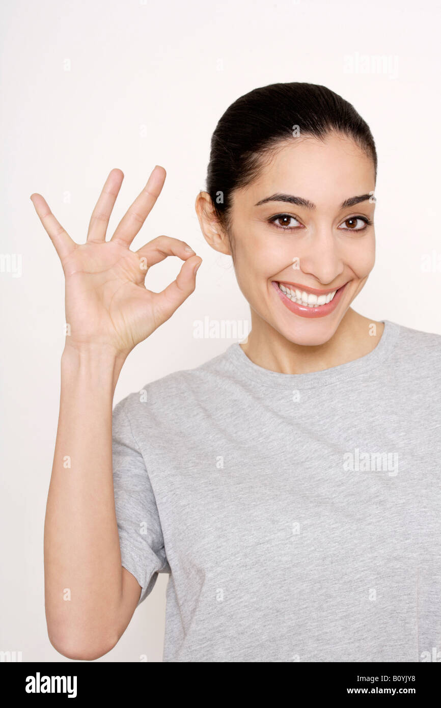 Young woman gesturing an ok sign, portrait Stock Photo - Alamy