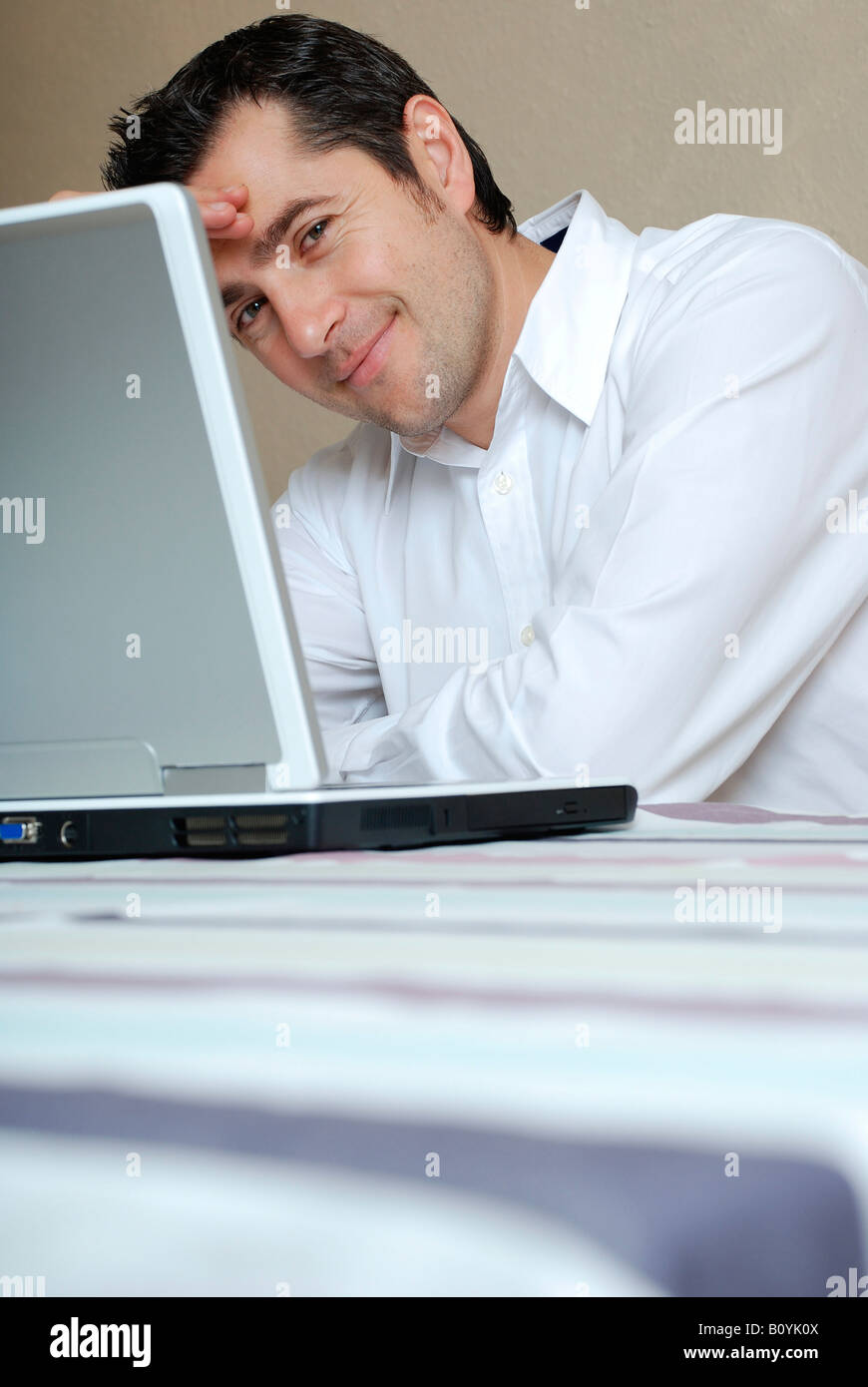 Young man with laptop, portrait Stock Photo - Alamy
