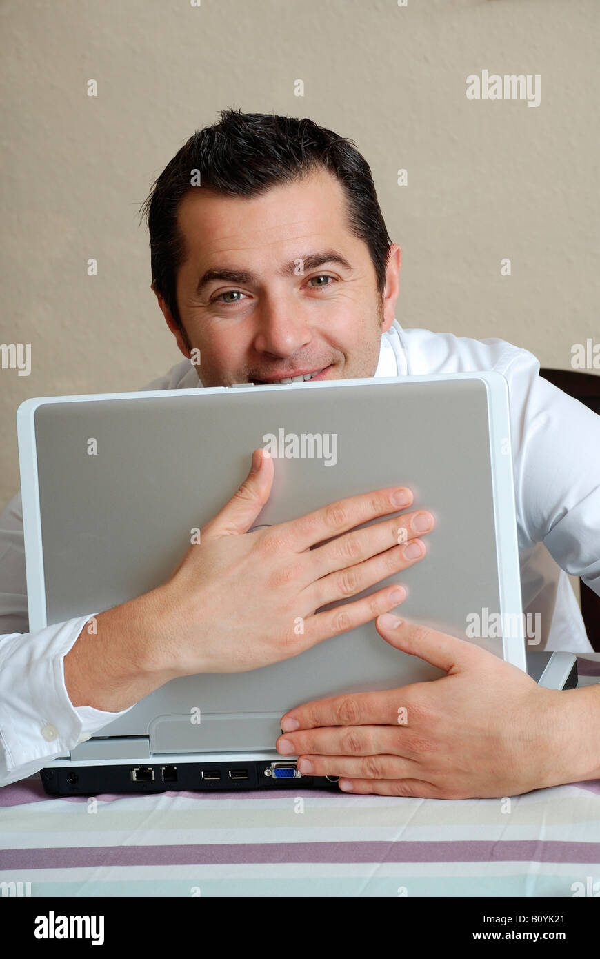 Young man with laptop, portrait Stock Photo - Alamy