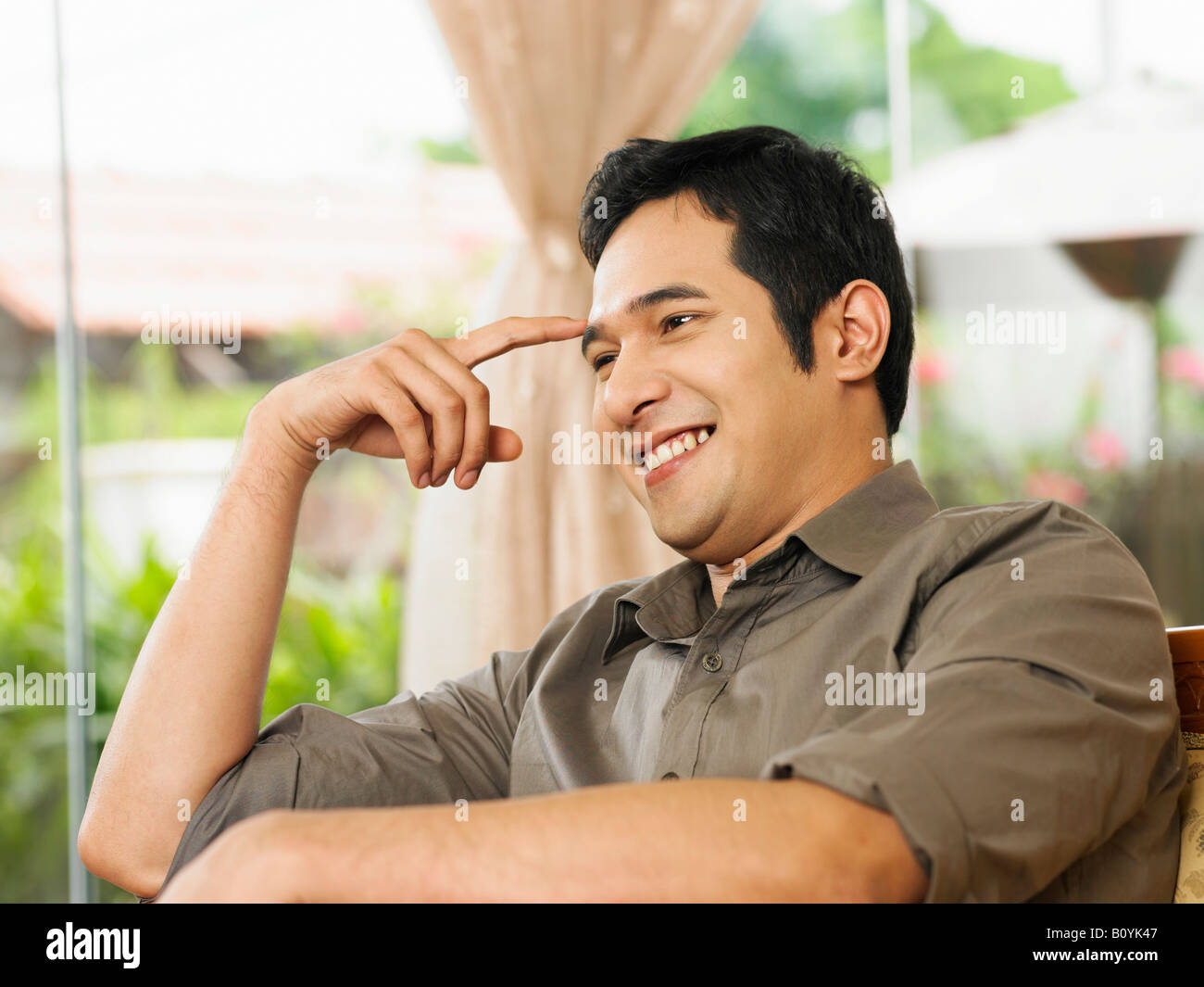 Single man thinking, smiling Stock Photo - Alamy