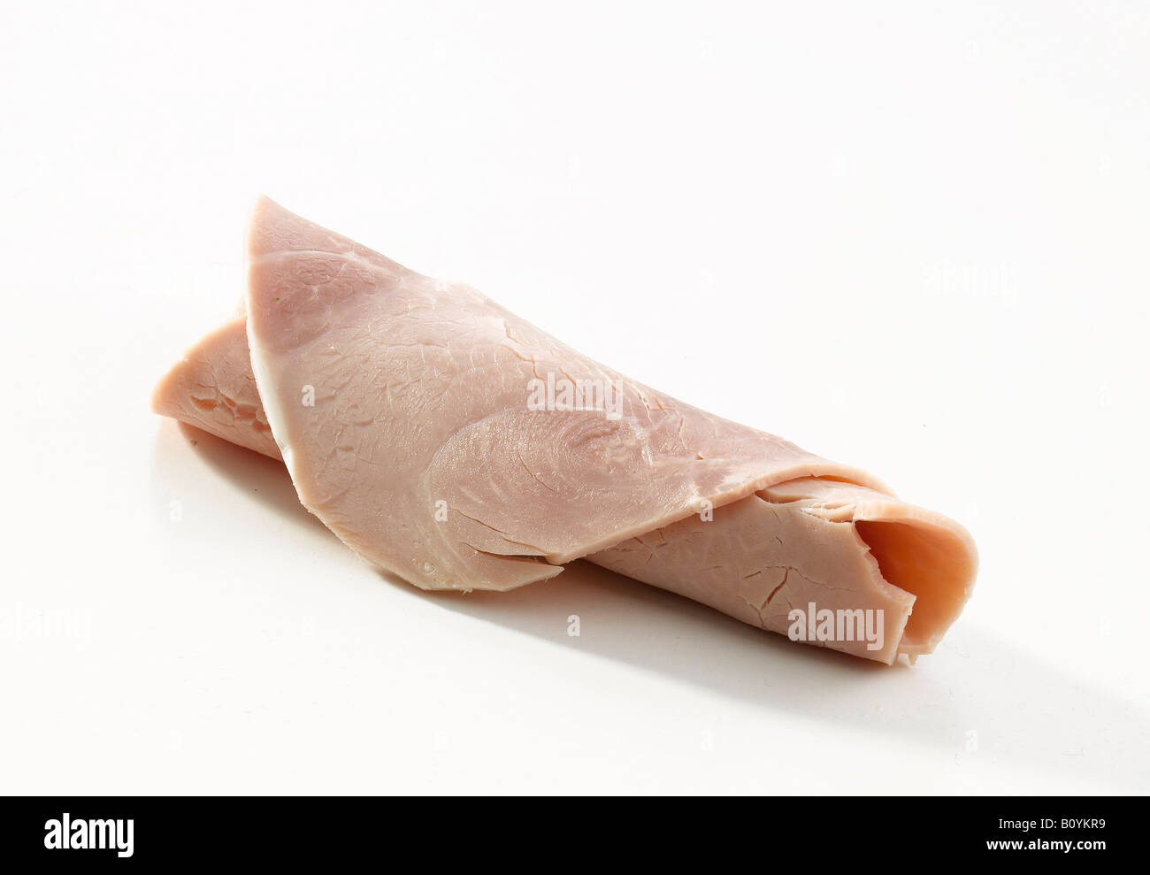 Rolled slice of cooked ham Stock Photo - Alamy