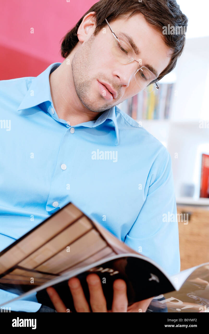 Young man reading a magazine Stock Photo - Alamy