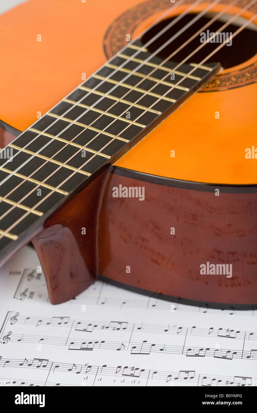 Acoustic guitar and sheet music Stock Photo - Alamy