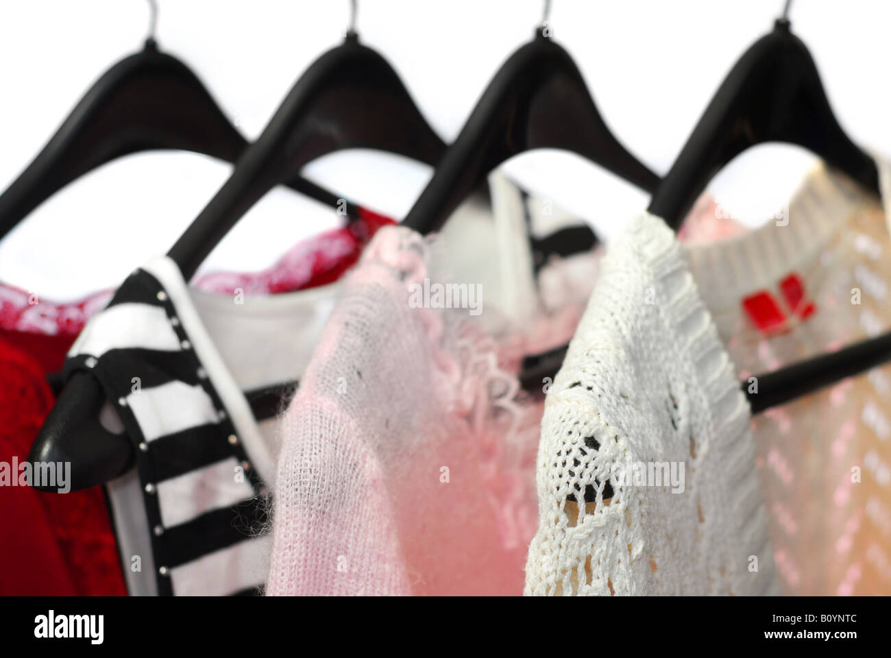 Women s clothing on a rack white background Stock Photo - Alamy
