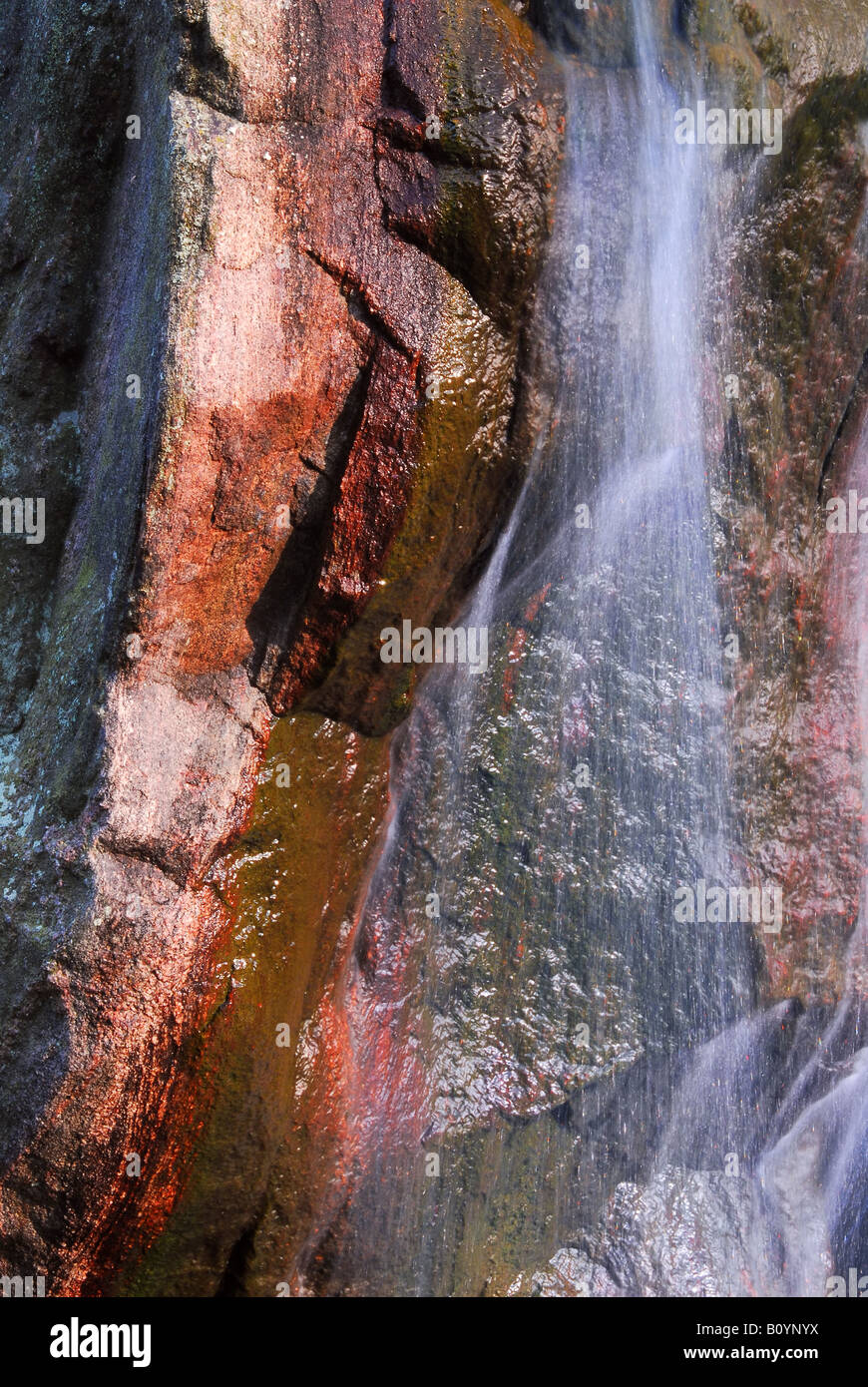 Water flowing down over big granite rock Stock Photo - Alamy