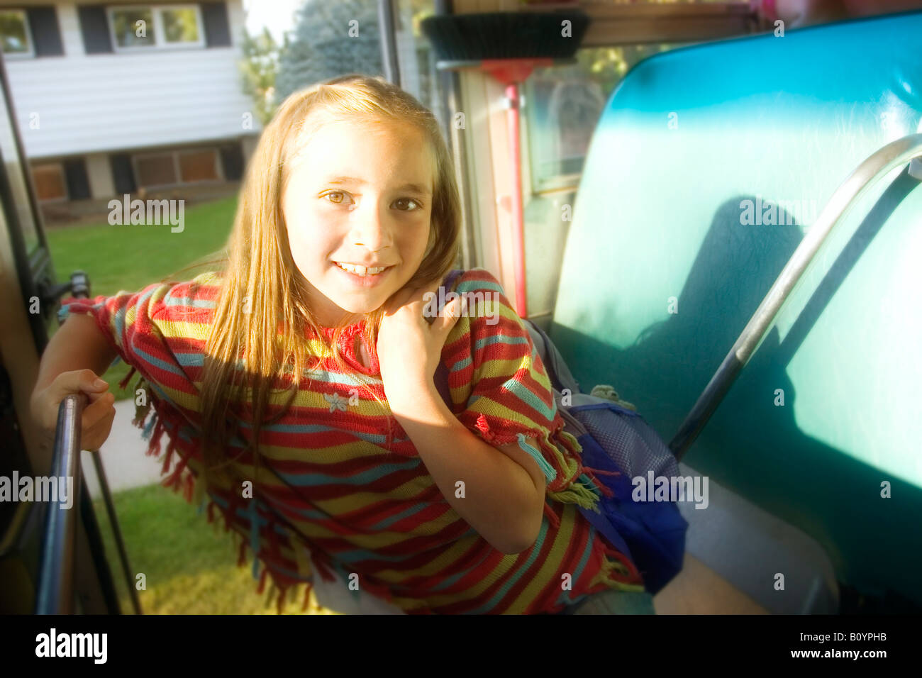 Child getting on school bus Stock Photo - Alamy