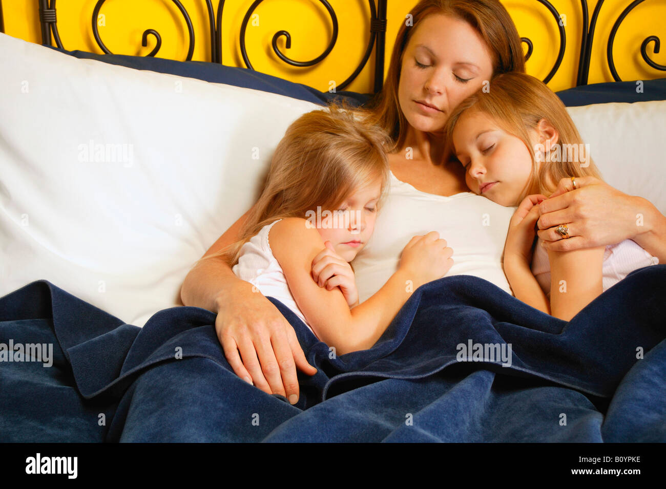 A mother resting with her children Stock Photo - Alamy