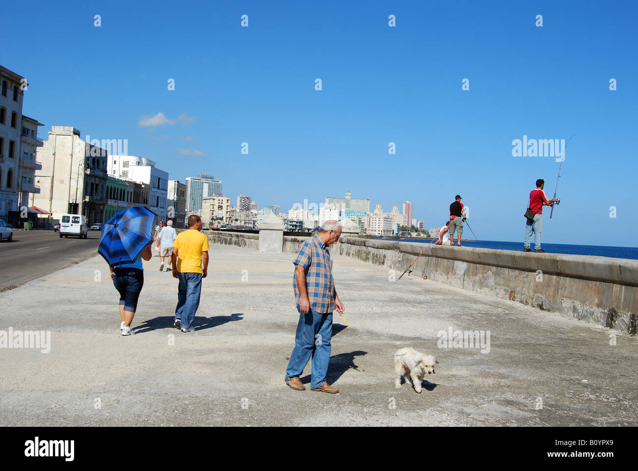 People walking along the Malecon Havana s famous sea wall, Cuba Stock ...