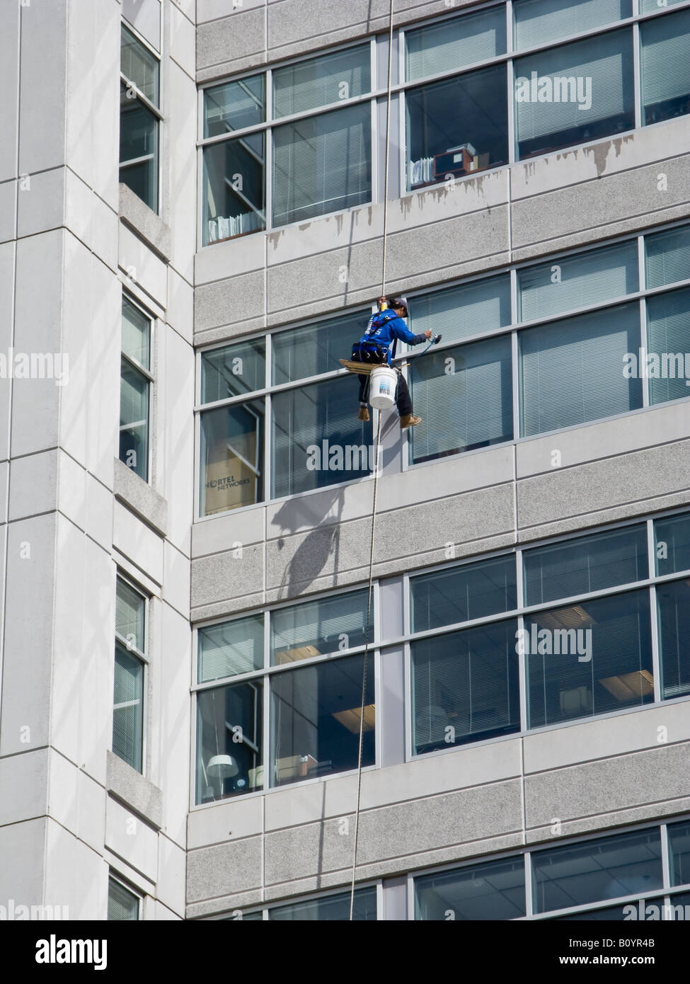 Worker washing windows on office building, Washington DC, USA Stock ...