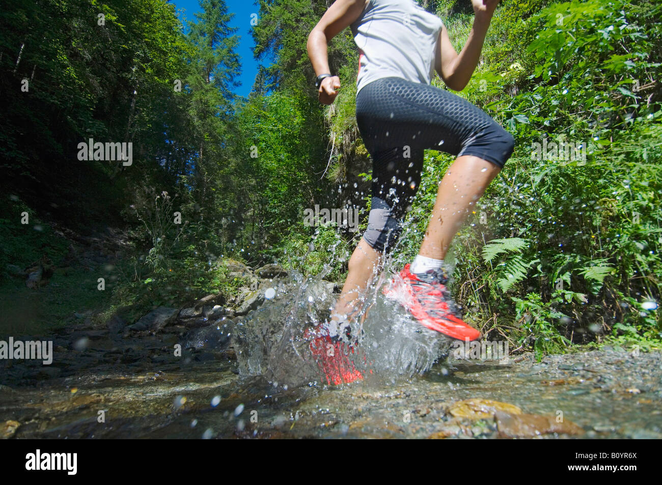 Young woman jogging across water Stock Photo - Alamy