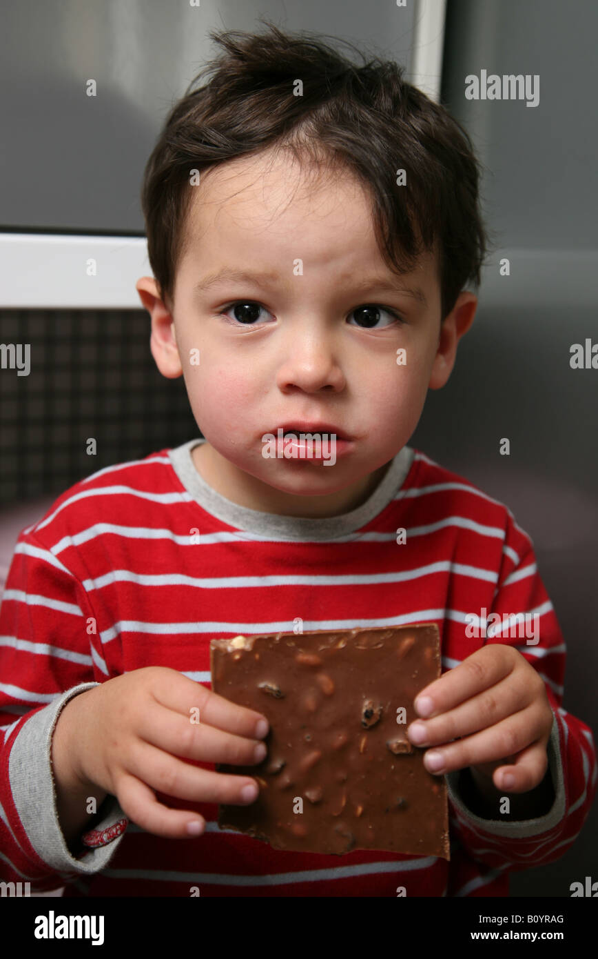 Toddler eating a large chocolate bar Stock Photo - Alamy