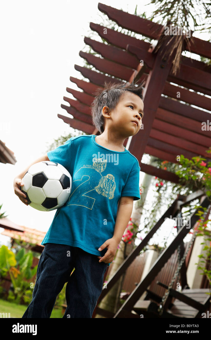 Young boy holding ball in one hand Stock Photo - Alamy