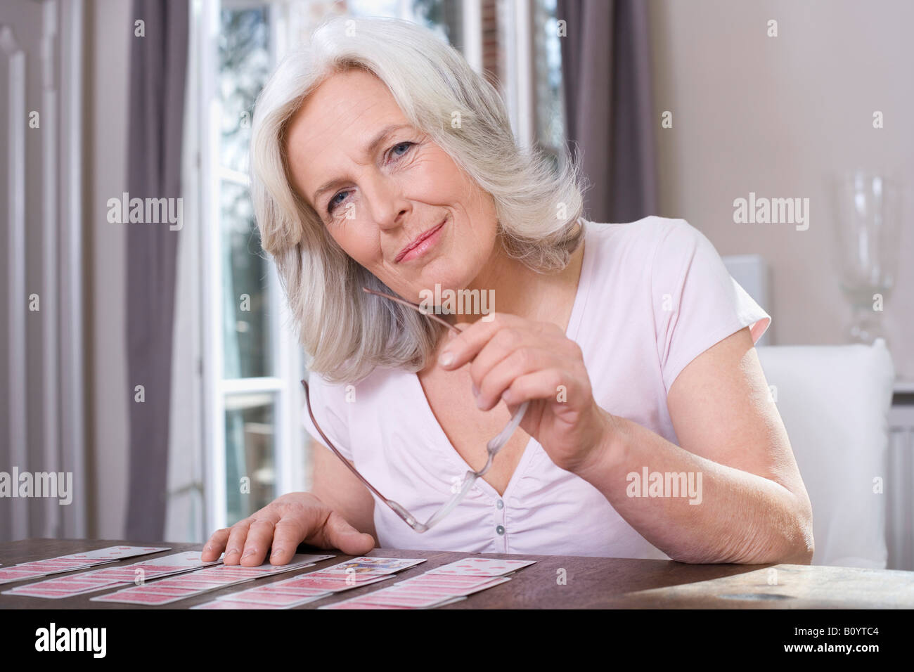 Woman playing solitaire card game hi-res stock photography and images ...
