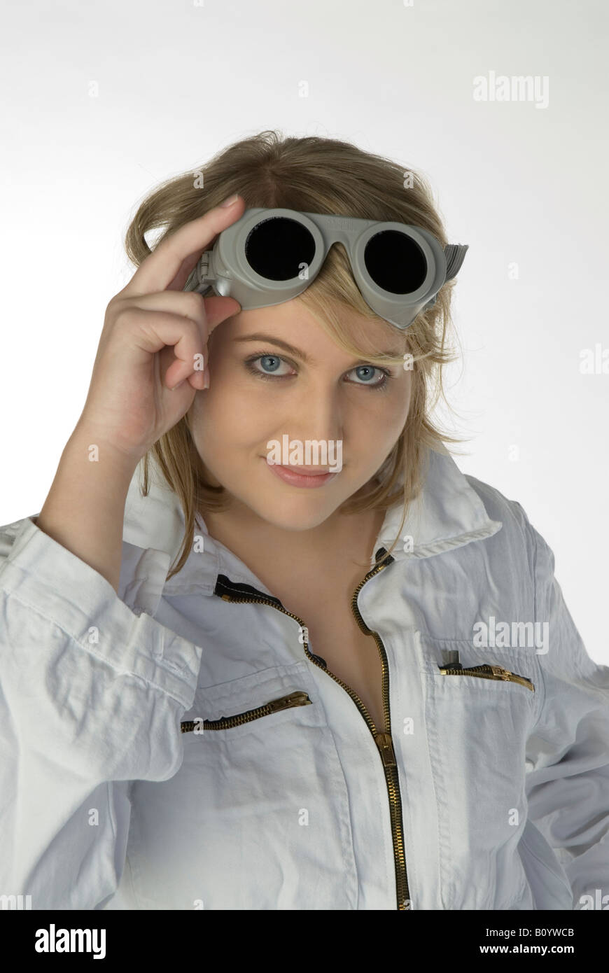 Blonde woman in overall and safety goggles, portrait Stock Photo - Alamy