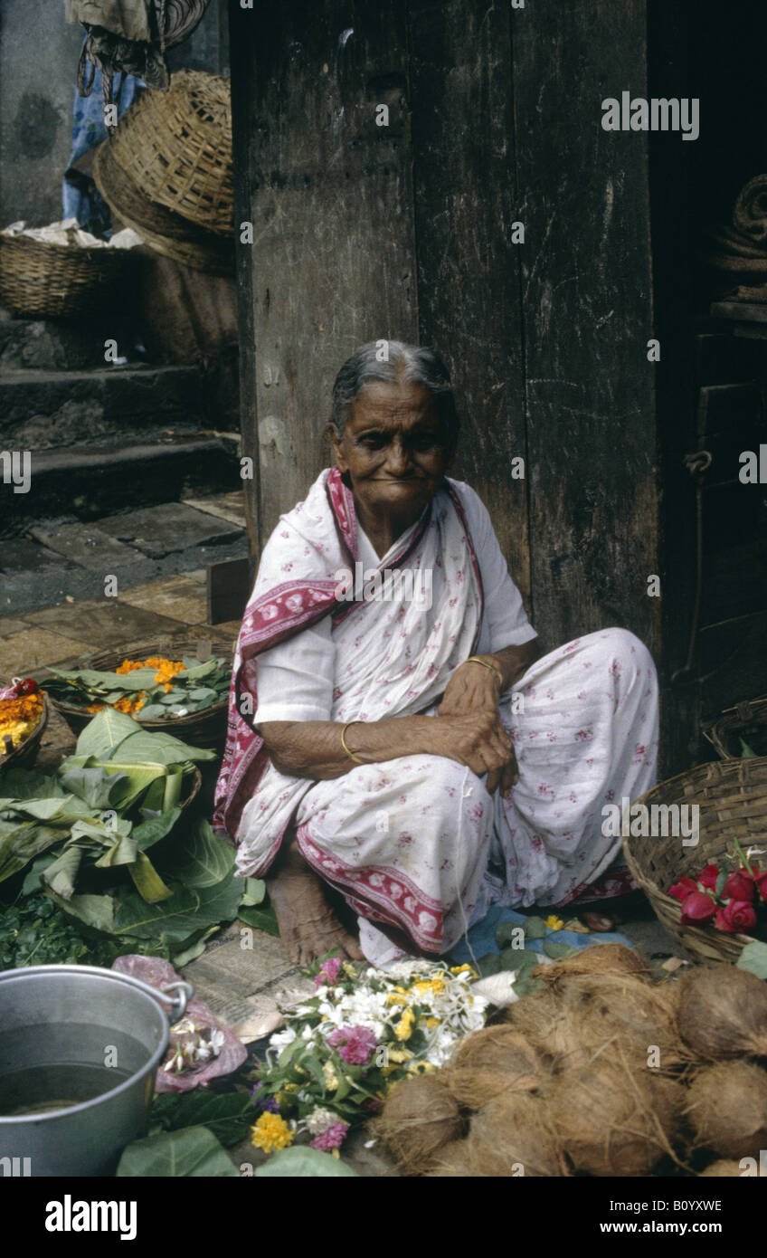 Old lady selling flowers and coconuts at Colaba Causeway BOMBAY INDIA ...