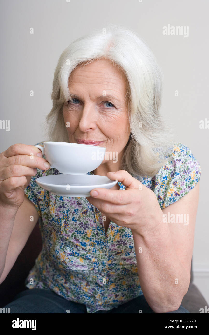 Senior woman drinking coffee, portrait Stock Photo - Alamy