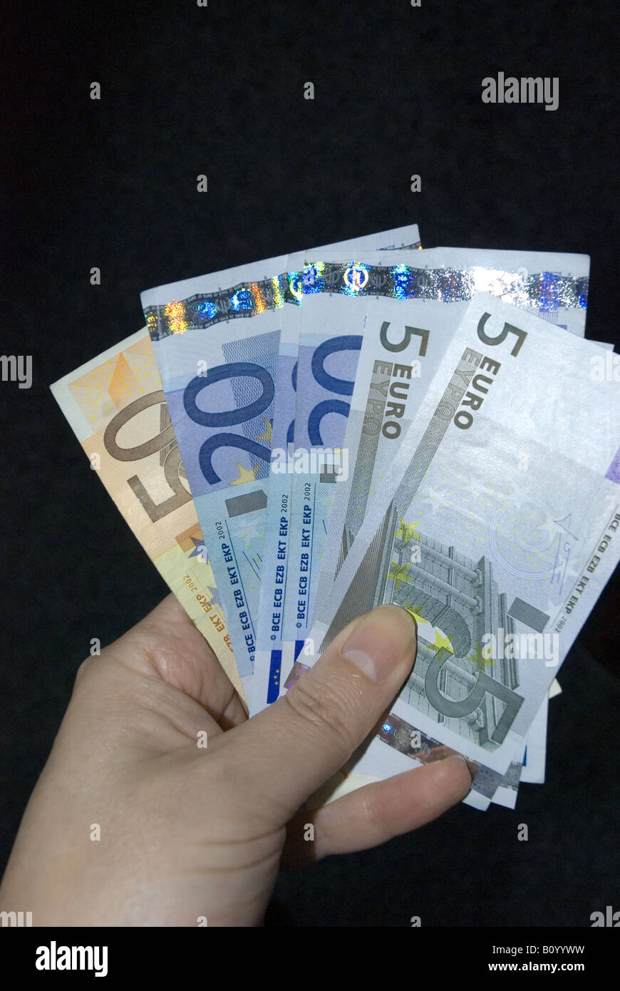 Euro notes held in a hand Stock Photo - Alamy