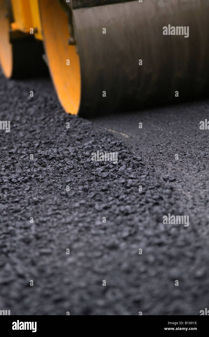 Rolling a new tarmacadam driveway Stock Photo - Alamy