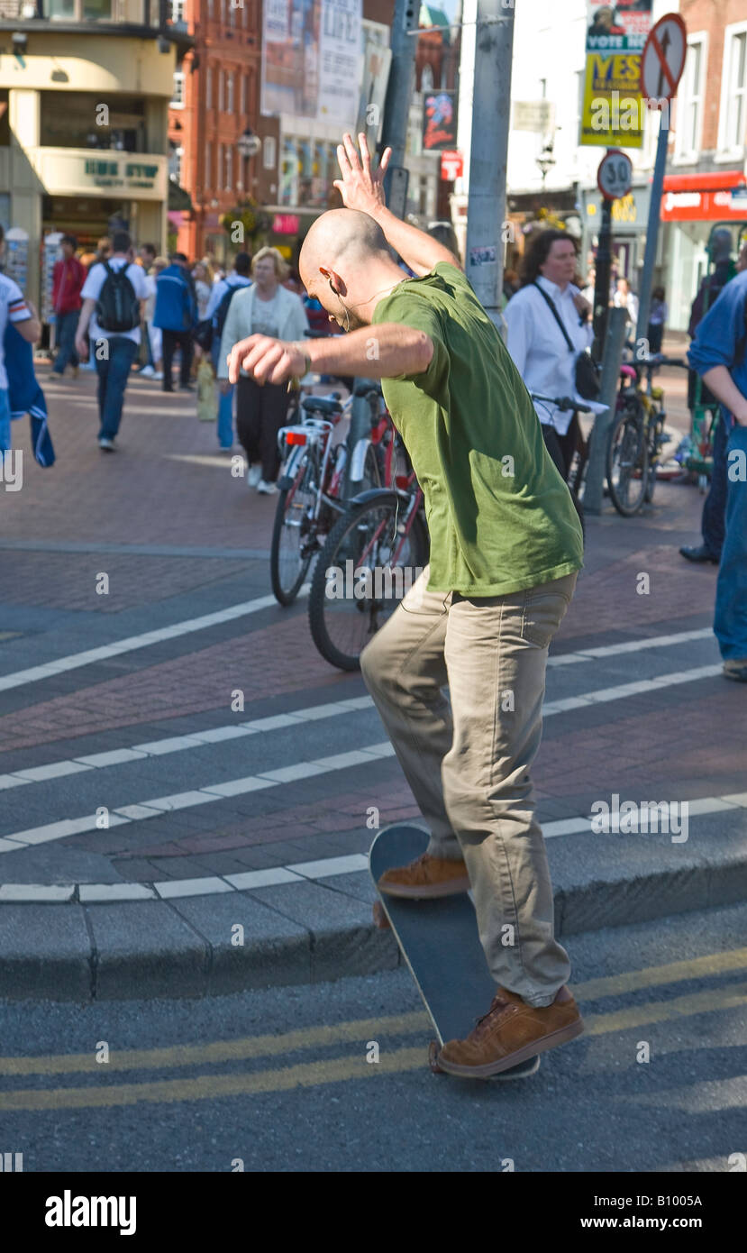male skateboarder mounting footpath Stock Photo - Alamy