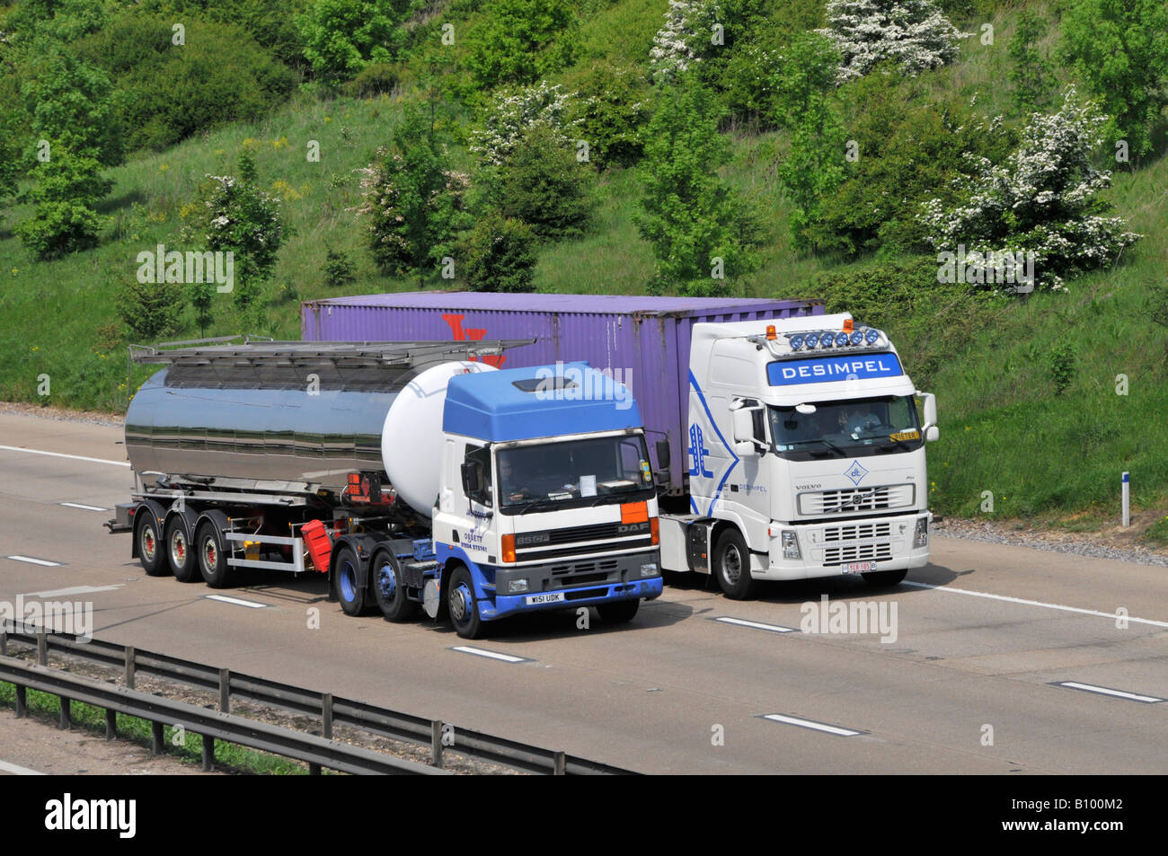 Two articulated lorries in overtaking manoeuvre on m25 motorway one ...