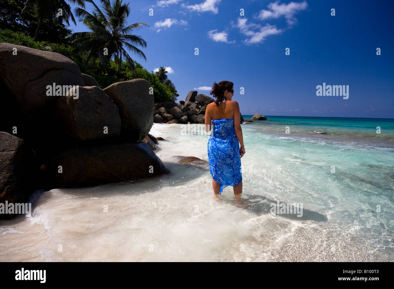 Young woman wading in water on beach in Seychelles Stock Photo - Alamy