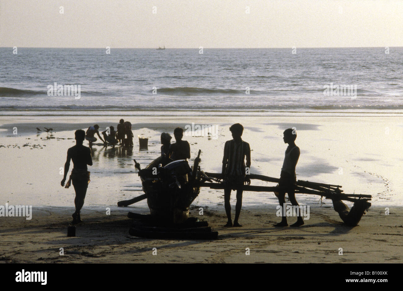 People with fishing boat on beach at sunset sunset goa india Stock ...