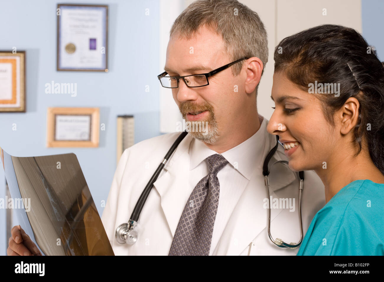 Doctor and nurse read a patient's x-ray to determine diagnosis Stock ...