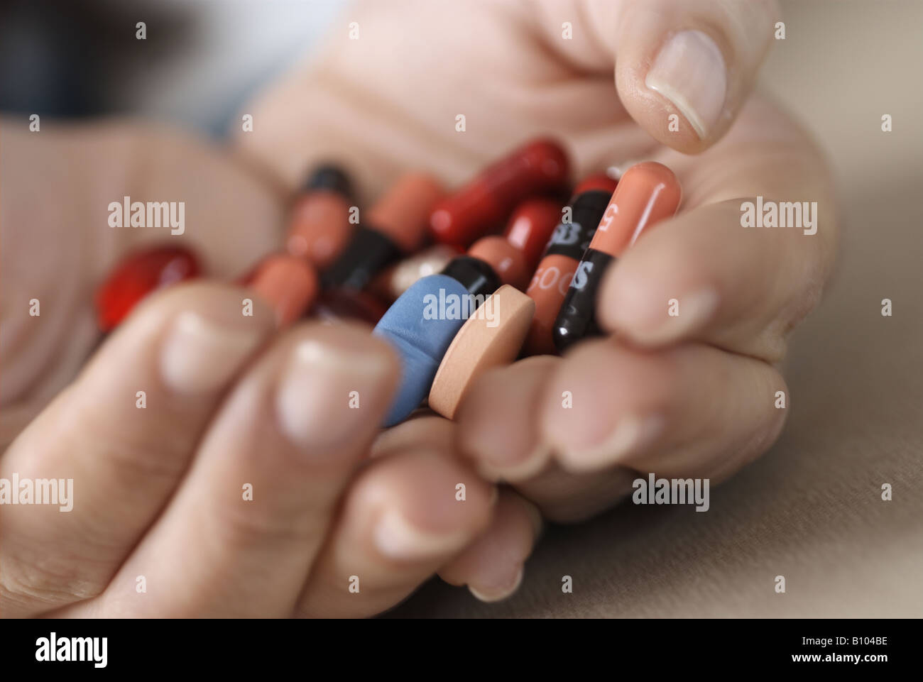 Two hands full of pills Stock Photo - Alamy