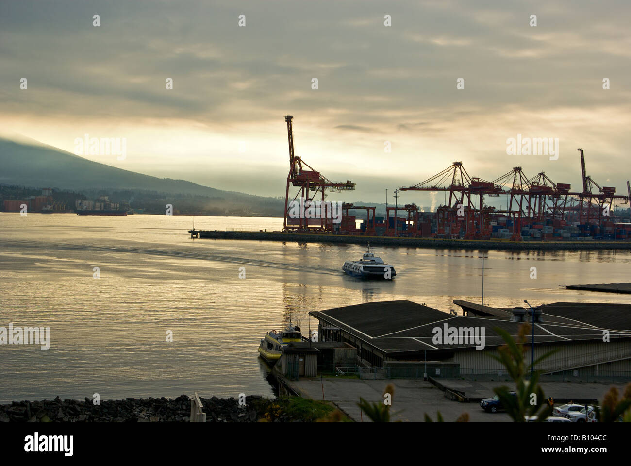 Commuter passenger ferry coming into terminal with Centennial container ...