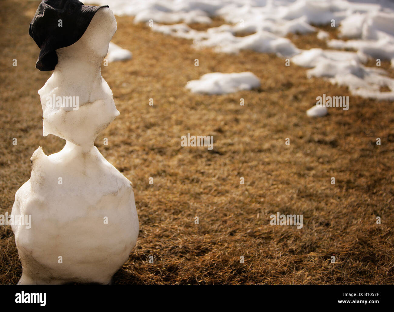 Snowman melting in spring Stock Photo - Alamy