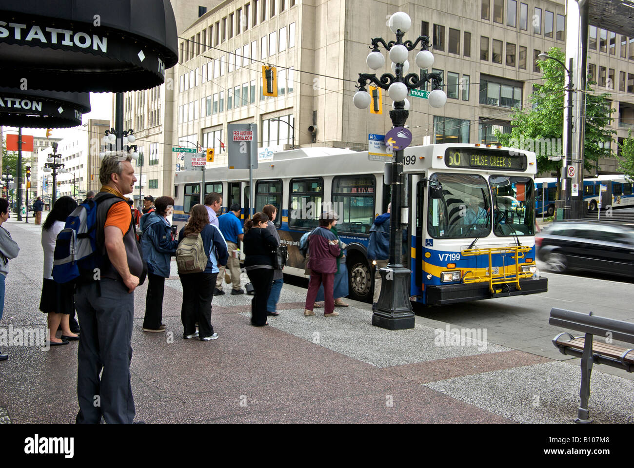 Morning commuters catching public transit bus at Waterfront Station ...