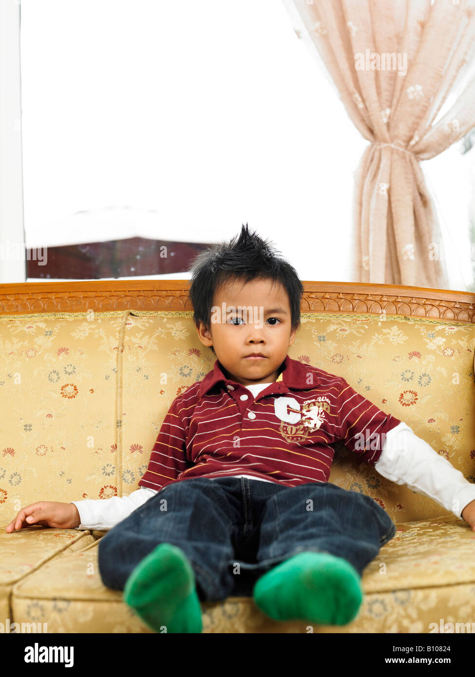 portrait of young boy sitting, alone Stock Photo - Alamy