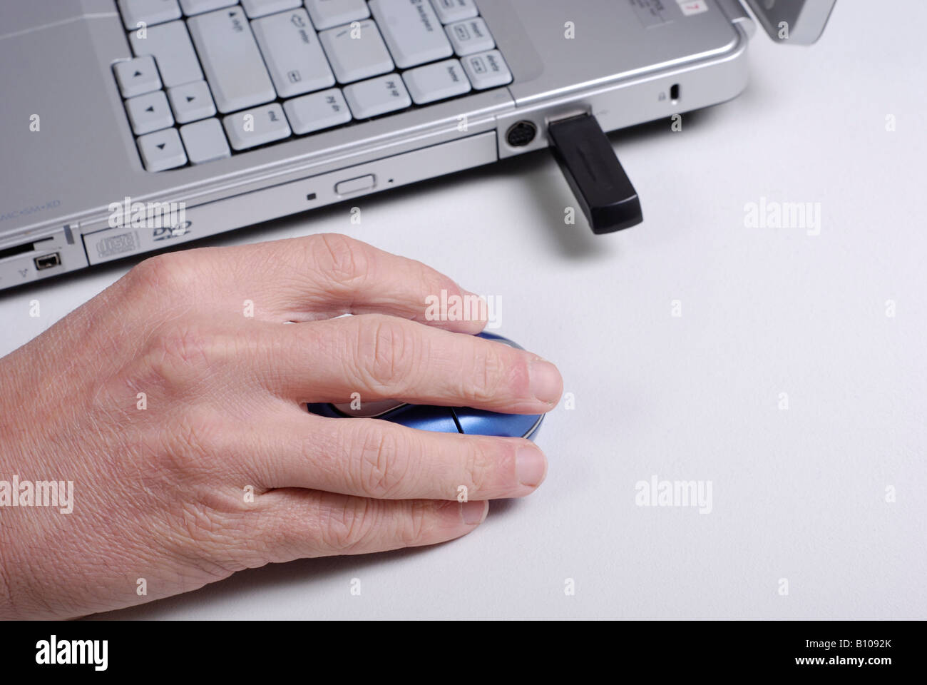 Laptop user with a mini usb wireless mouse Stock Photo - Alamy