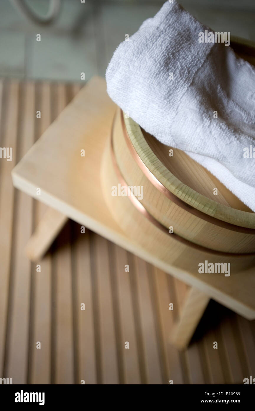 Detail of typical wooden stool basin and towel inside bathroom of ...