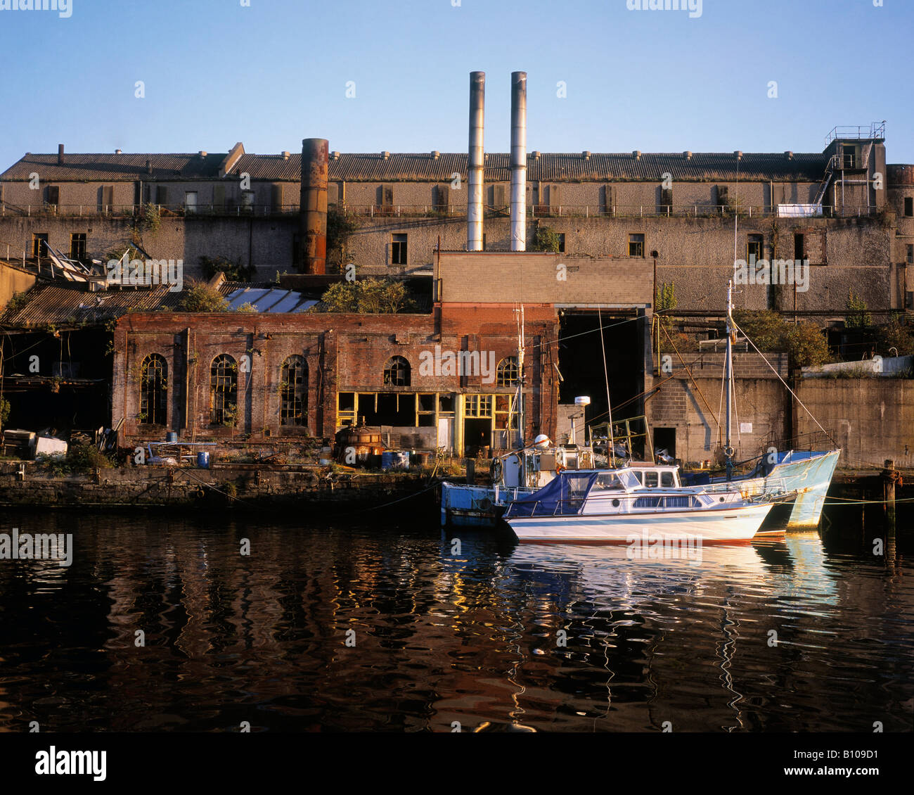 Fishing boats near a derelict factory, River Boyne, Drogheda, Co Louth ...