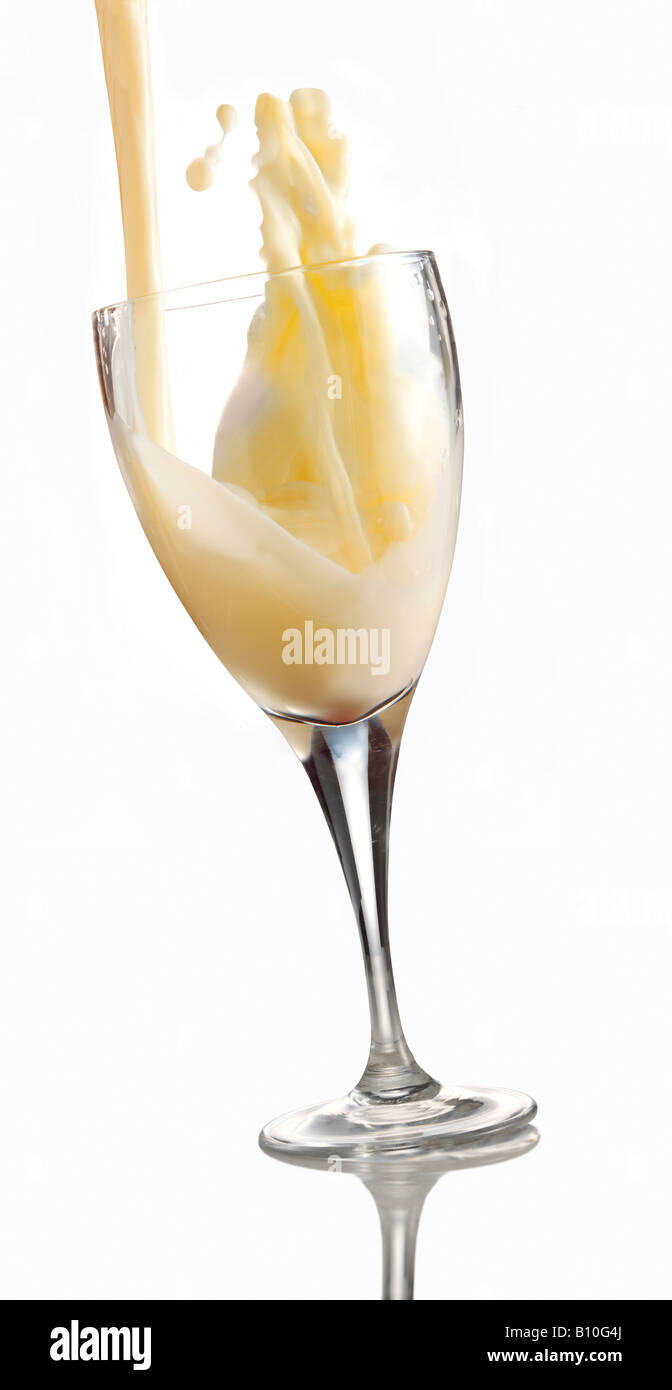 Milk Shake being poured into a glass against a white background Stock ...