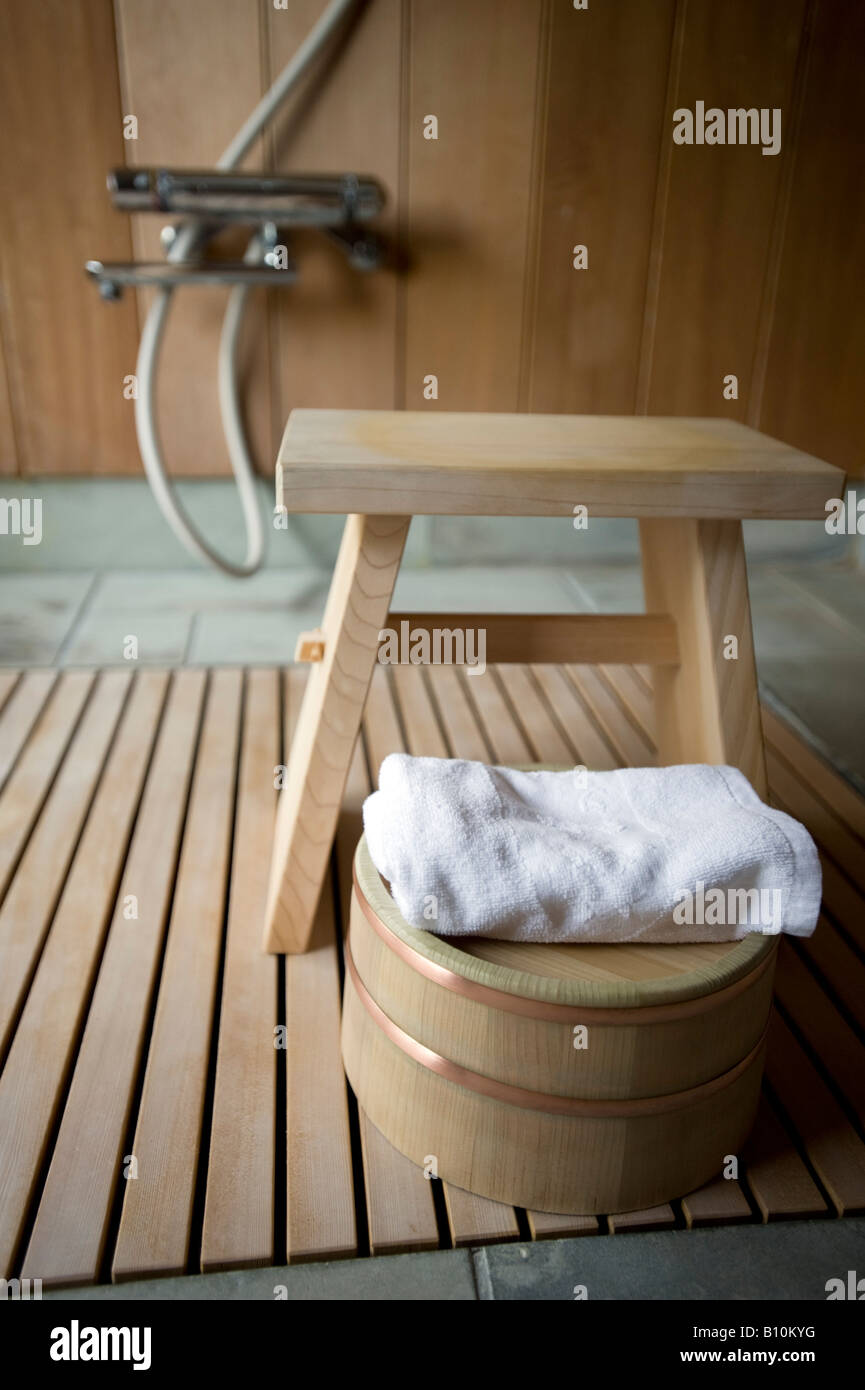 Detail of typical wooden stool basin and towel inside bathroom of ...