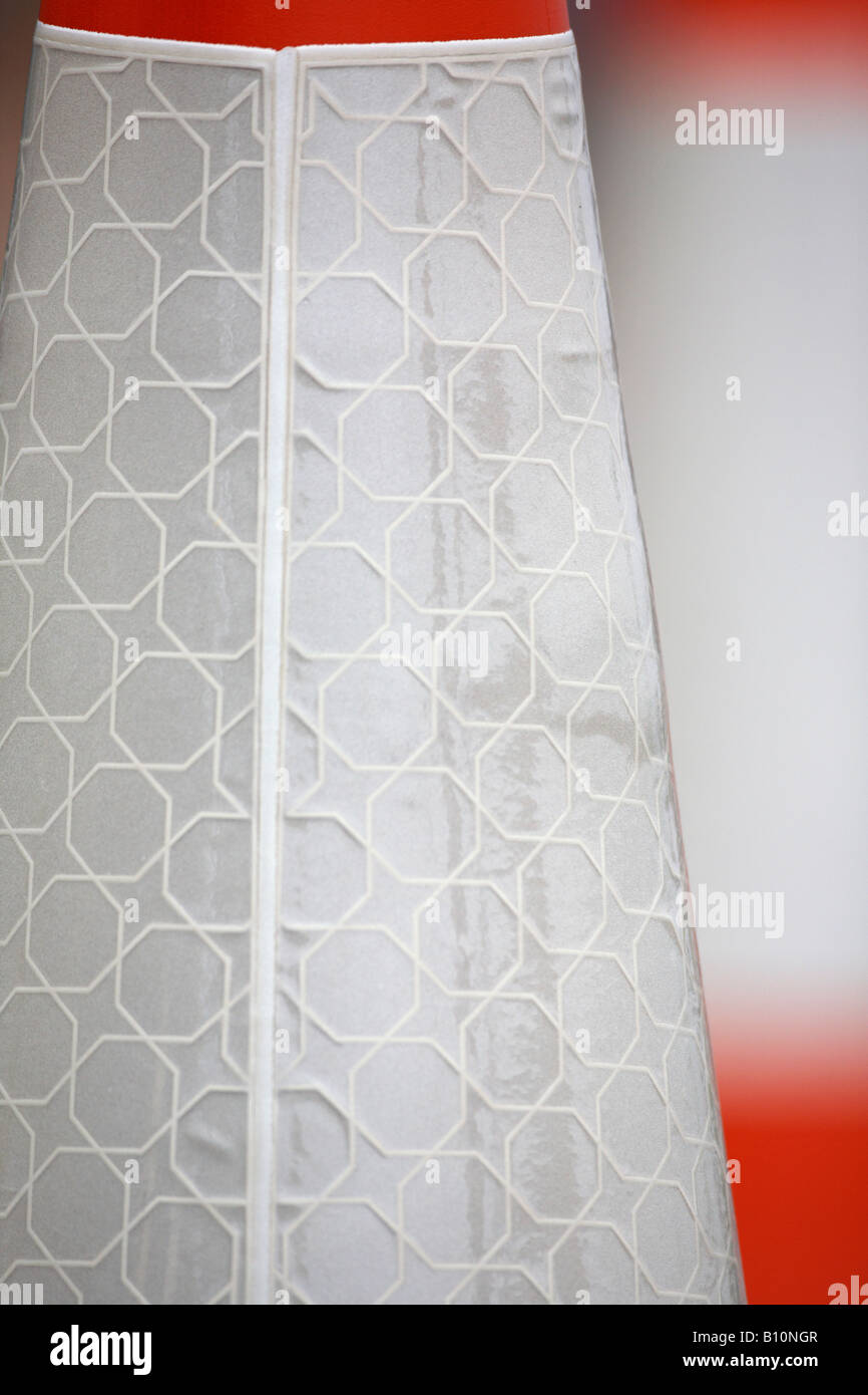 single traffic cone close up in a line of traffic cones showing pattern ...