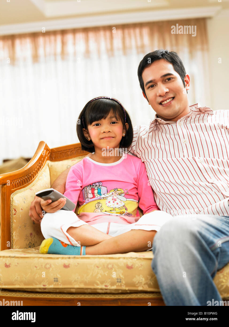 father and daughter watching tv programme Stock Photo - Alamy