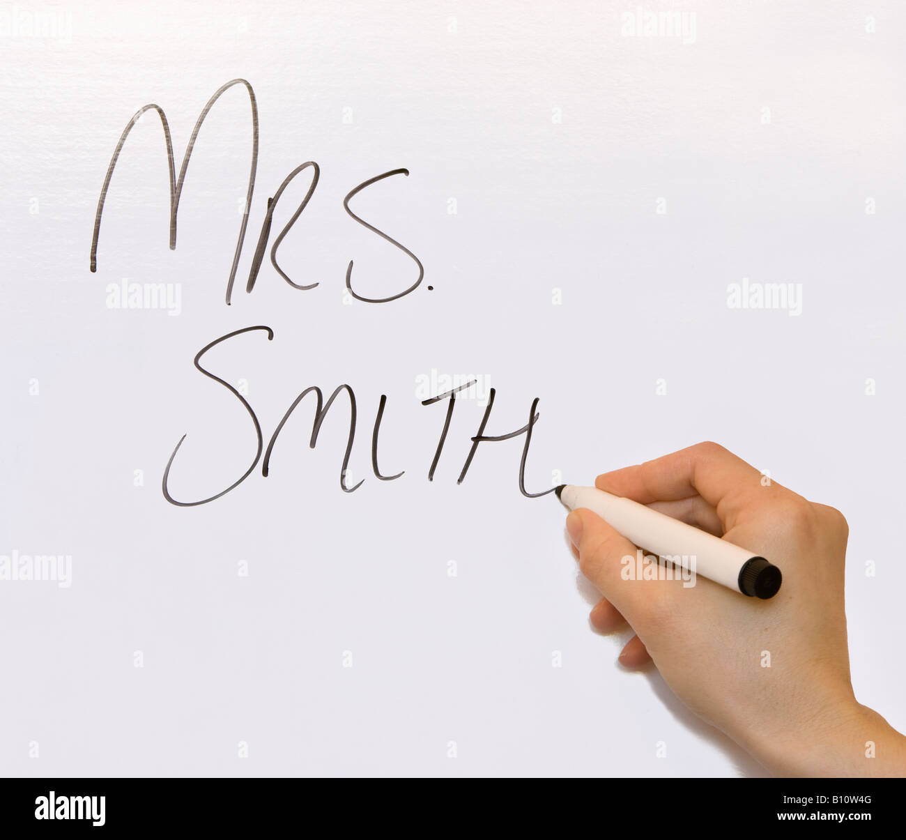 A teacher writing her name on a whiteboard Stock Photo - Alamy